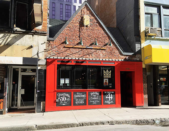 A neon beacon in the night, 4th Wall's red door beckons like a culinary Bat-Signal. Who needs the Batcave when you've got this?