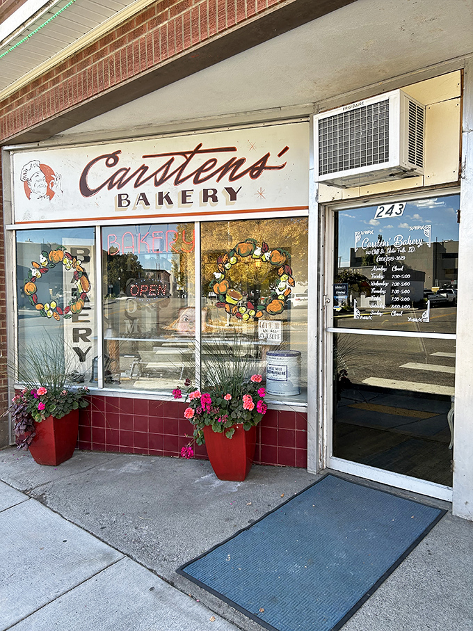 Welcome to carb heaven! This unassuming brick facade hides a treasure trove of baked delights, crowned by a giant pretzel sign that's basically a bat-signal for pastry lovers.