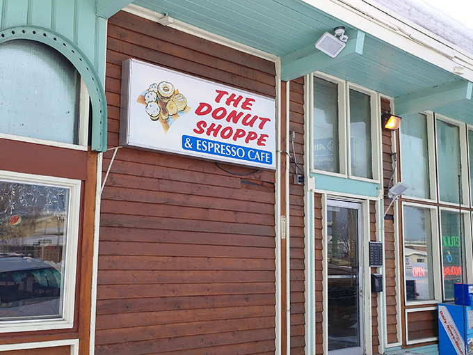 A mint-green time machine! This charming exterior promises a journey back to simpler days when donuts ruled the breakfast kingdom.