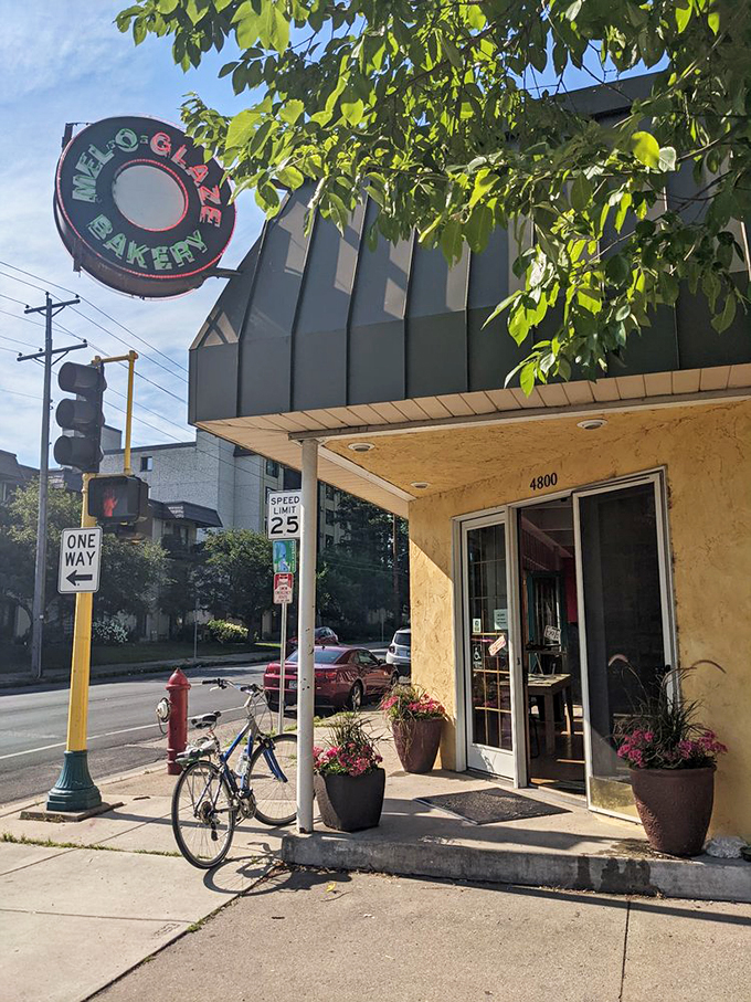 A yellow beacon of sugary salvation! Mel-O-Glaze Bakery stands unassumingly on the corner, its retro sign promising sweet delights within. It's like stumbling upon Willy Wonka's secret Midwest outpost.