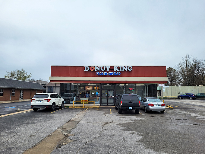 Behold, the neon-lit palace of pastry perfection! Donut King's sign shines like a beacon, guiding sugar-seekers to their glazed destiny.
