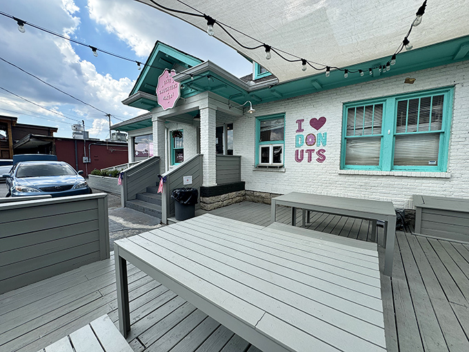 A sugar-coated wonderland awaits! Five Daughters Bakery's charming exterior promises sweet delights, with its teal trim and inviting patio beckoning donut lovers like a siren's call.