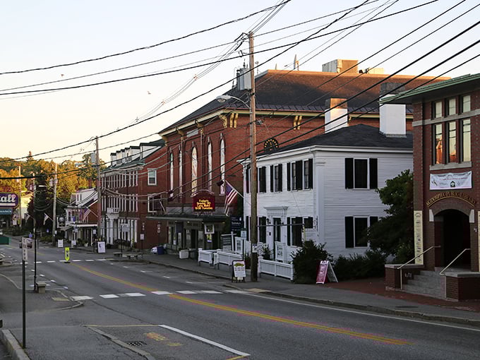 Damariscotta's Main Street: Where Norman Rockwell meets coastal charm. Red brick buildings and white clapboards stand shoulder-to-shoulder, whispering tales of centuries past.