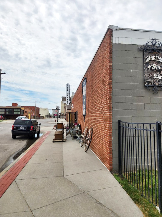 Step right up, folks! This brick behemoth isn't just a building; it's a portal to treasure-hunting paradise. The "FLEA MARKET" sign practically winks at you, promising adventures in antiquing.