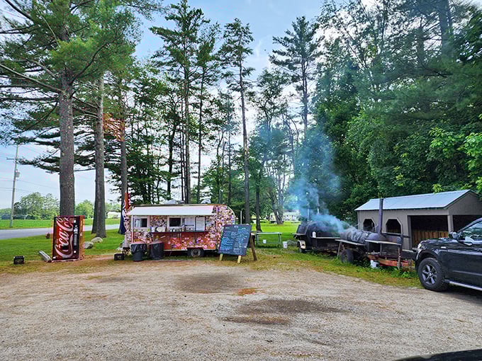 Welcome to BBQ paradise! This colorful food truck, nestled among towering pines, is where smoke signals spell out "delicious."