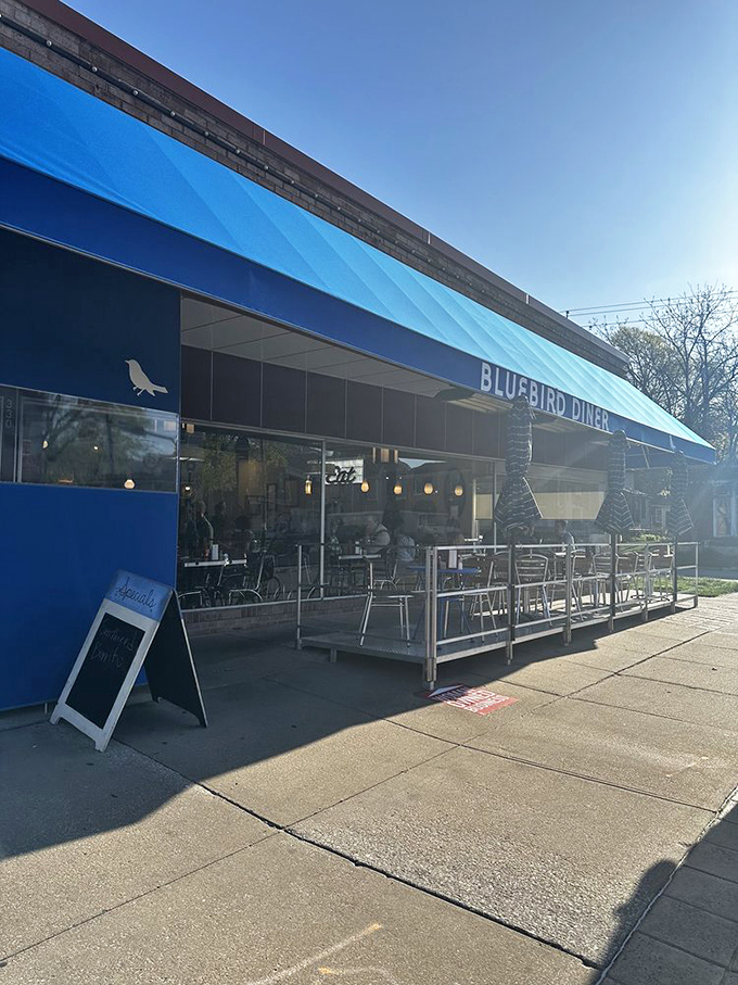 A blue beacon of breakfast bliss! The Bluebird Diner's cheery exterior promises comfort food that'll make your taste buds sing like Julie Andrews on a mountaintop.
