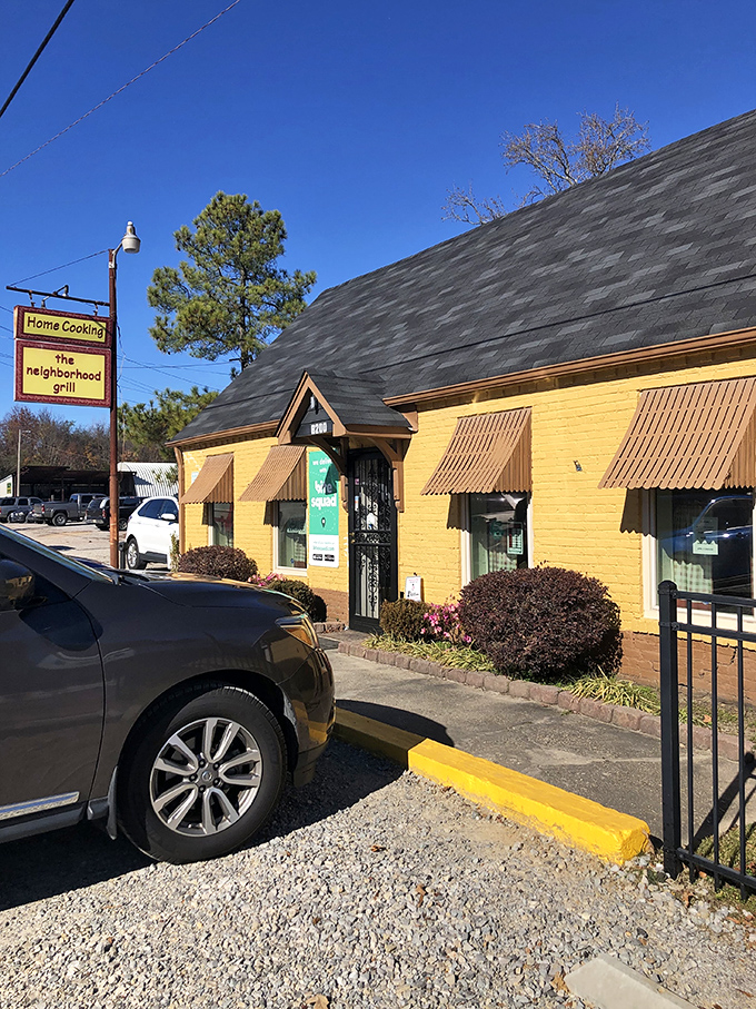 A sunny slice of Southern charm! This cheerful yellow building with its inviting brown awnings is like a warm hug for your taste buds.