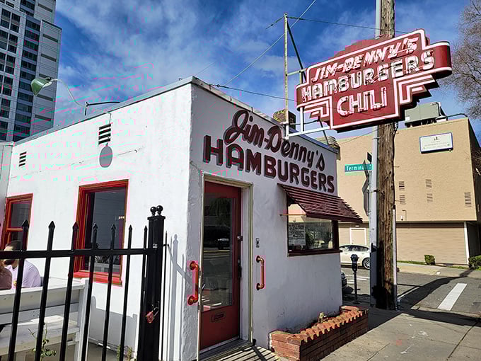 A time machine disguised as a diner! Jim Denny's iconic facade stands proud, its retro sign a beacon for hungry time travelers seeking a taste of nostalgia.