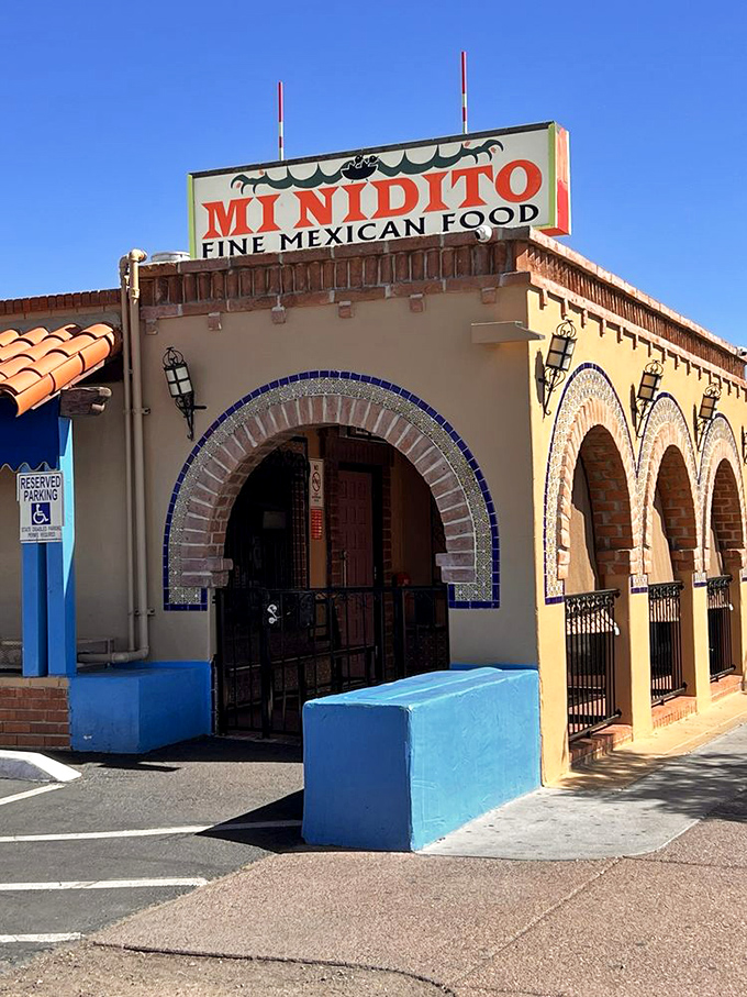 Welcome to flavor town! Mi Nidito's charming exterior promises a fiesta for your taste buds, with its inviting arches and sun-kissed facade.