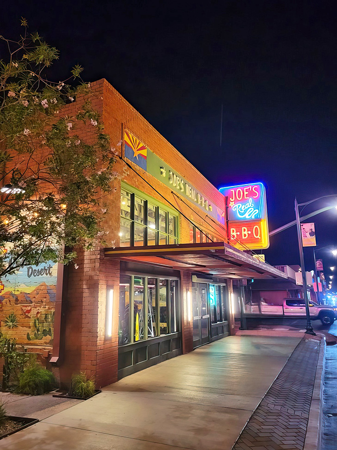 Neon dreams and BBQ schemes! Joe's Real BBQ lights up the night like a smoky beacon for meat lovers.