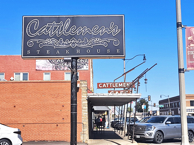 A sign that says "Come for the steak, stay for the history." Cattlemen's iconic exterior beckons meat lovers with its vintage charm and promise of beefy delights.