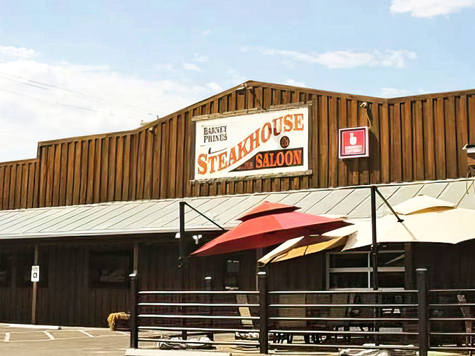 Welcome to beef paradise! Barney Prine's rustic exterior promises a steak-lover's dream, with those red umbrellas beckoning like beacons of deliciousness.
