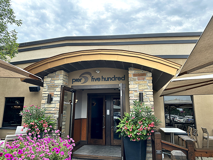 Welcome to Pier 500, where the entrance is as inviting as a warm Wisconsin hug. Flower-filled planters and stone accents beckon you into this riverside gem.