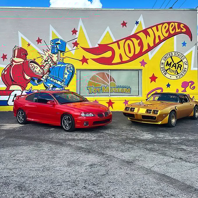 Childhood dreams come to life! This vibrant mural is like a Hot Wheels track come to life, with G.I. Joe and Barbie cheering from the sidelines.