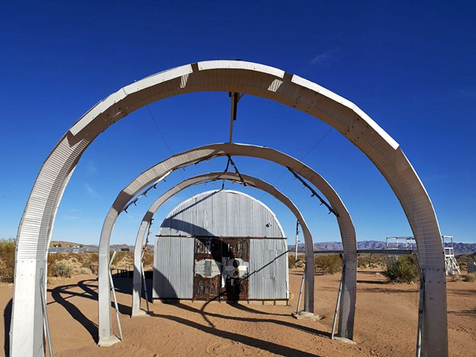 Welcome to the Twilight Zone of art! This arched entrance beckons you into a world where creativity knows no bounds and junk becomes genius.