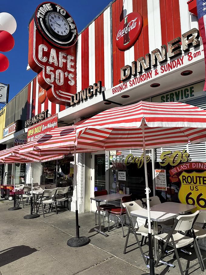 Welcome to the land of sock hops and soda jerks! Cafe 50's exterior screams "American Graffiti" come to life, with its bold red-and-white stripes promising a trip down memory lane.