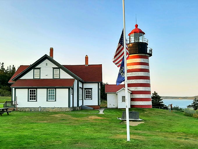 Candy-striped sentinel of the sea! This iconic lighthouse stands guard over Maine's rugged coastline, a beacon of hope and Instagram likes.