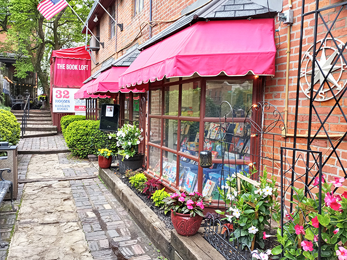 Step into a storybook world! The Book Loft's charming exterior promises literary adventures behind its brick fa&ccedil;ade and vibrant red awnings.