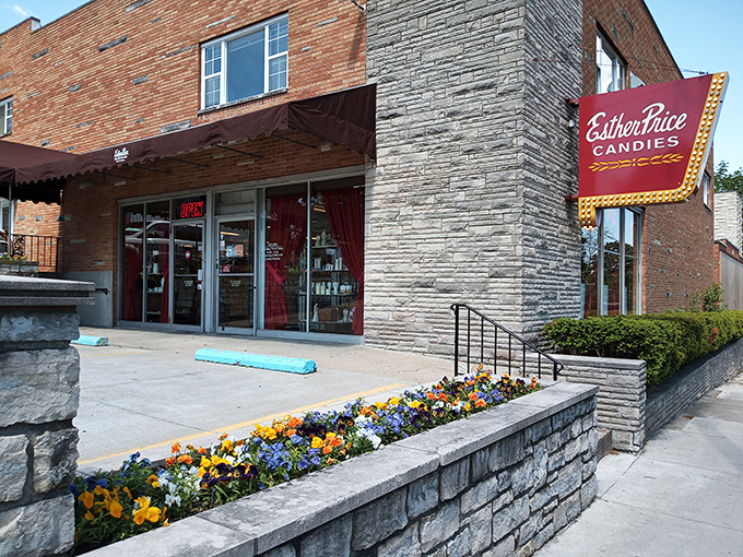A chocolate lover's beacon! Esther Price Candies' storefront beckons with its classic brick facade and vibrant floral welcome, promising sweet adventures within.