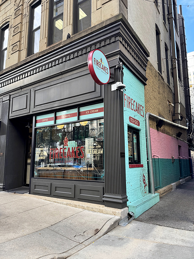 A teal oasis in the concrete jungle! Firecakes Donuts beckons with its charming storefront, promising sweet salvation for weary urbanites.