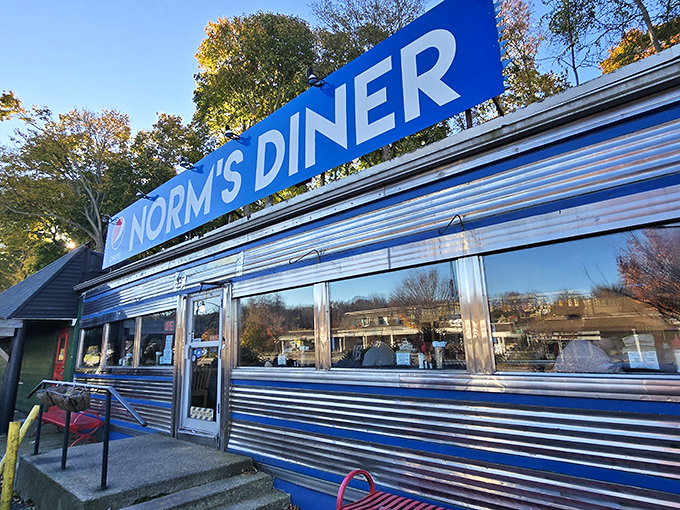 A slice of Americana, served with a side of nostalgia. Norm's Diner stands proud, its blue-trimmed exterior promising comfort food and friendly faces within.