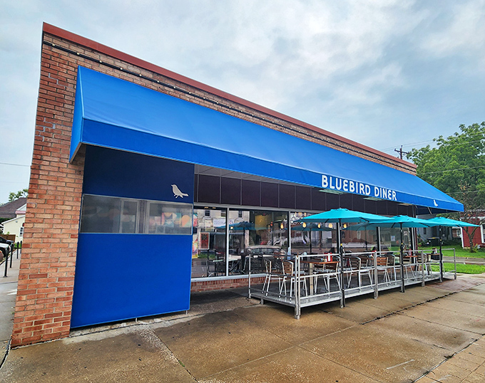 A blue beacon of breakfast bliss! The Bluebird Diner's cheery exterior promises comfort food that'll make your taste buds sing like Julie Andrews on a mountaintop.