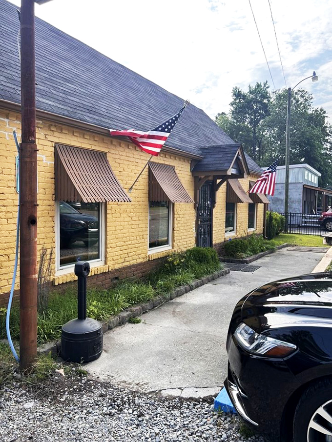 A sunny slice of Southern charm! This cheerful yellow building with its inviting brown awnings is like a warm hug for your taste buds.