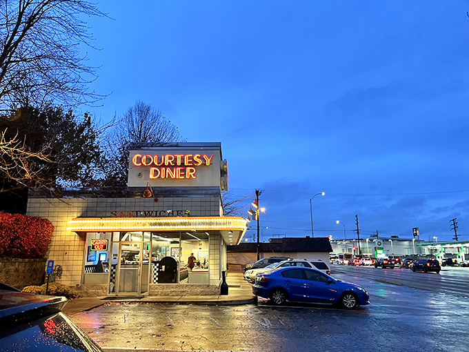 Neon dreams come true! Courtesy Diner's retro sign beckons like a lighthouse for the hungry, promising comfort food and a slice of Americana.