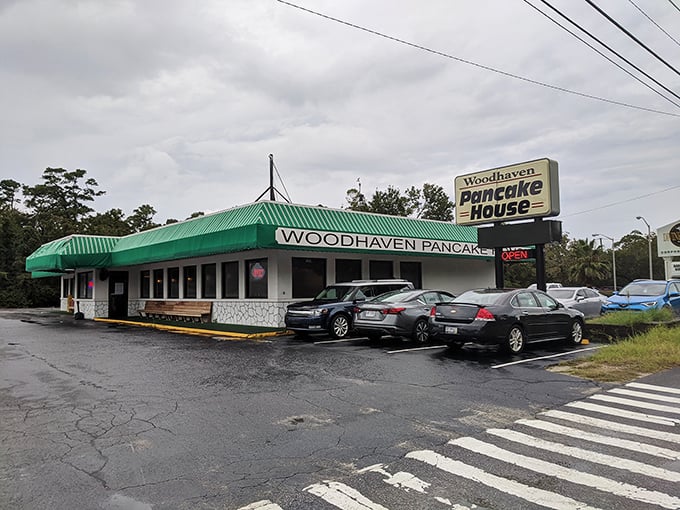 A green-striped awning beckons like a breakfast lighthouse, guiding hungry souls to this unassuming pancake paradise. No frills, just thrills for your taste buds.