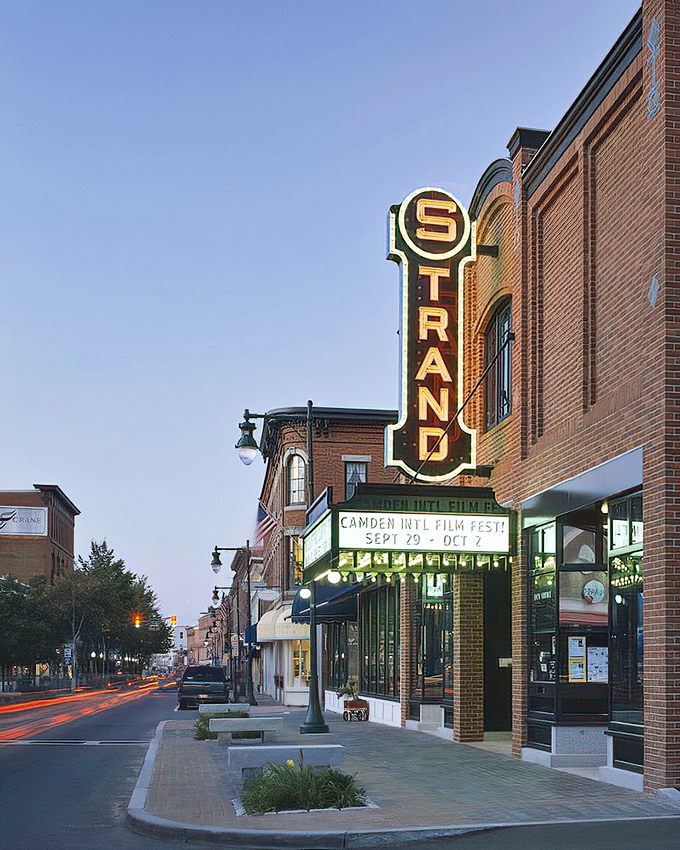 Lights, camera, action! The Strand Theatre's iconic sign beckons movie lovers into a world where classic charm meets modern entertainment on Rockland's Main Street.