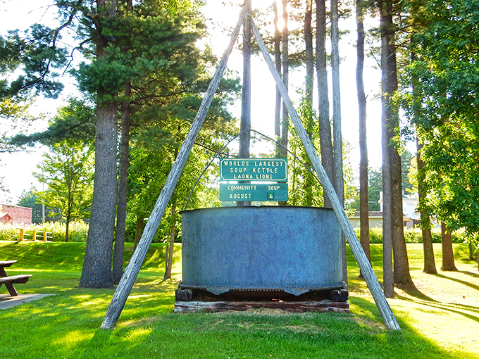 A soup-er sight to behold! This colossal kettle stands tall among the pines, ready to serve up a hearty dose of small-town charm.