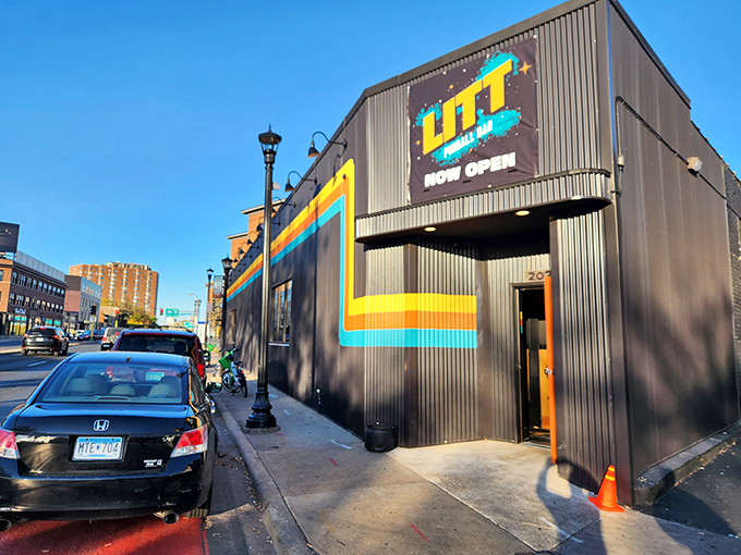 Welcome to LITT Pinball Bar, where the neon sign beckons like a lighthouse for lost souls seeking refuge in nostalgia and craft beer.