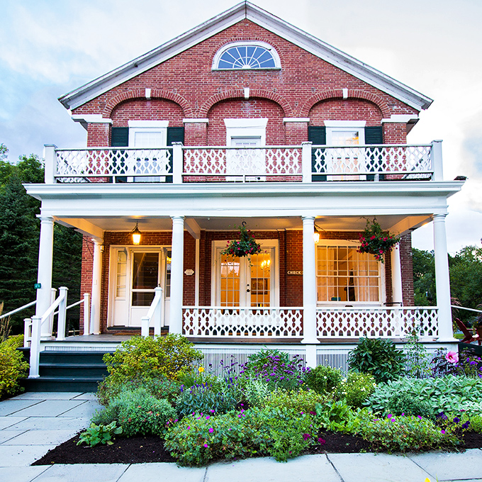 A storybook come to life! This charming red brick fa&ccedil;ade with its white-columned porch whispers tales of lazy summer evenings and hot cocoa by the fire.