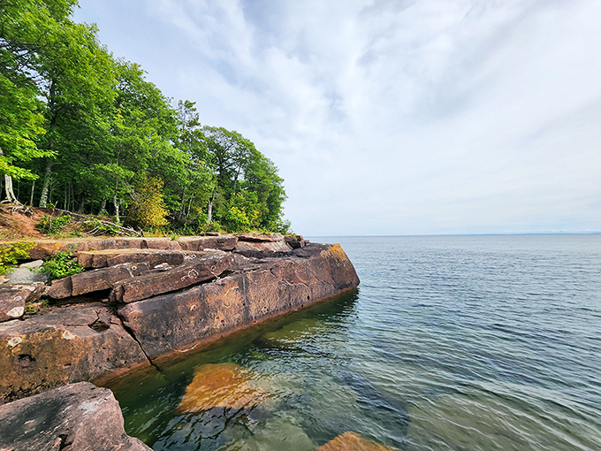 Nature's canvas unfolds: Rugged rocks meet lush forests at the water's edge. Big Bay State Park's shoreline is a masterpiece that would make Bob Ross proud.