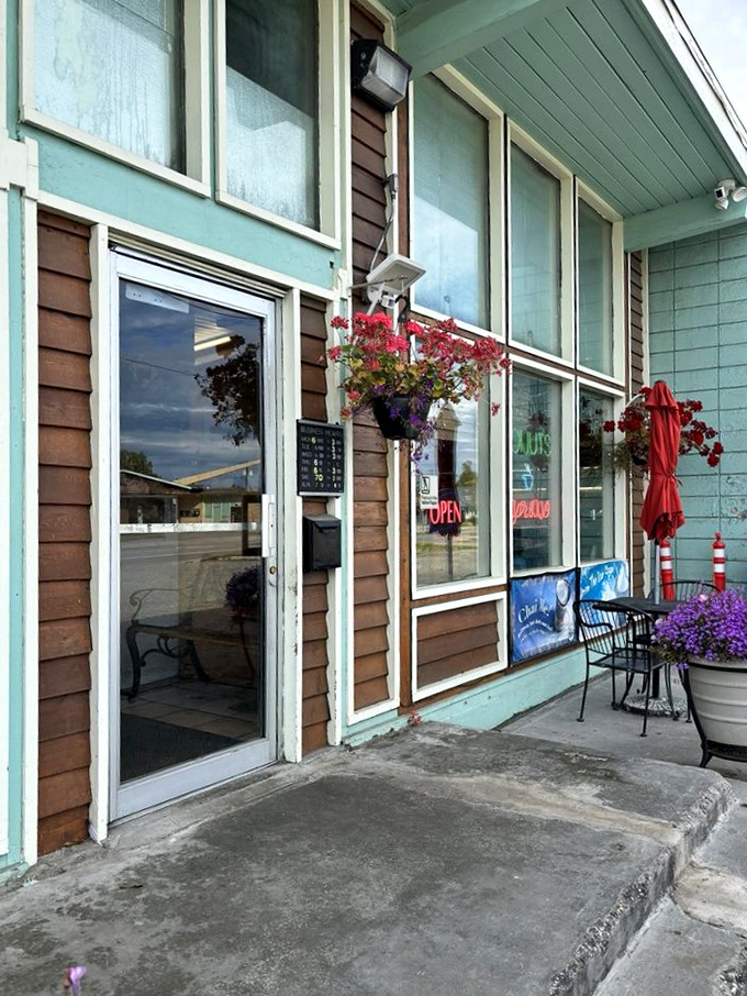 A mint-green time machine! This charming exterior promises a journey back to simpler days when donuts ruled the breakfast kingdom.