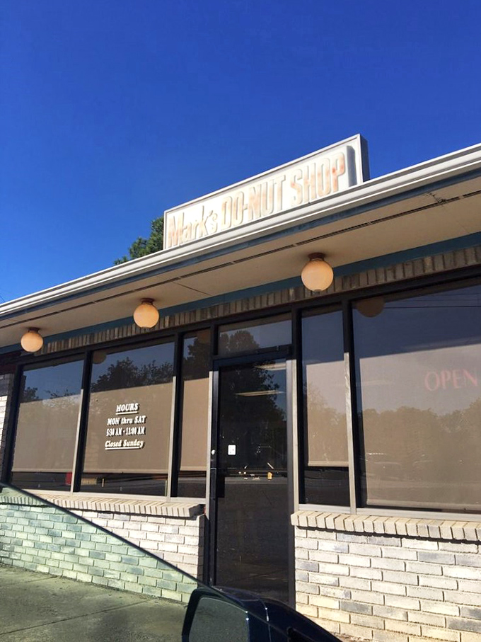 A humble brick facade hides a world of sugary wonders. Mark's Do-Nut Shop: where dreams come glazed, frosted, and filled.