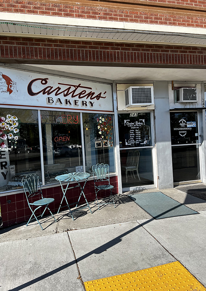 Welcome to carb heaven! This unassuming brick facade hides a treasure trove of baked delights, crowned by a giant pretzel sign that's basically a bat-signal for pastry lovers.