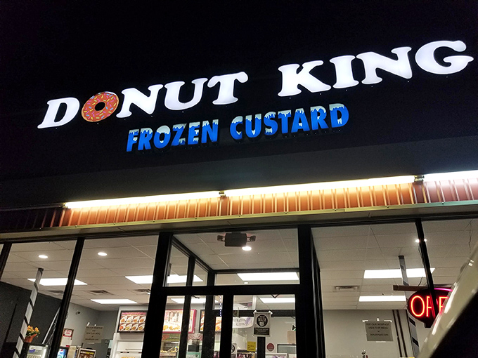 Behold, the neon-lit palace of pastry perfection! Donut King's sign shines like a beacon, guiding sugar-seekers to their glazed destiny.