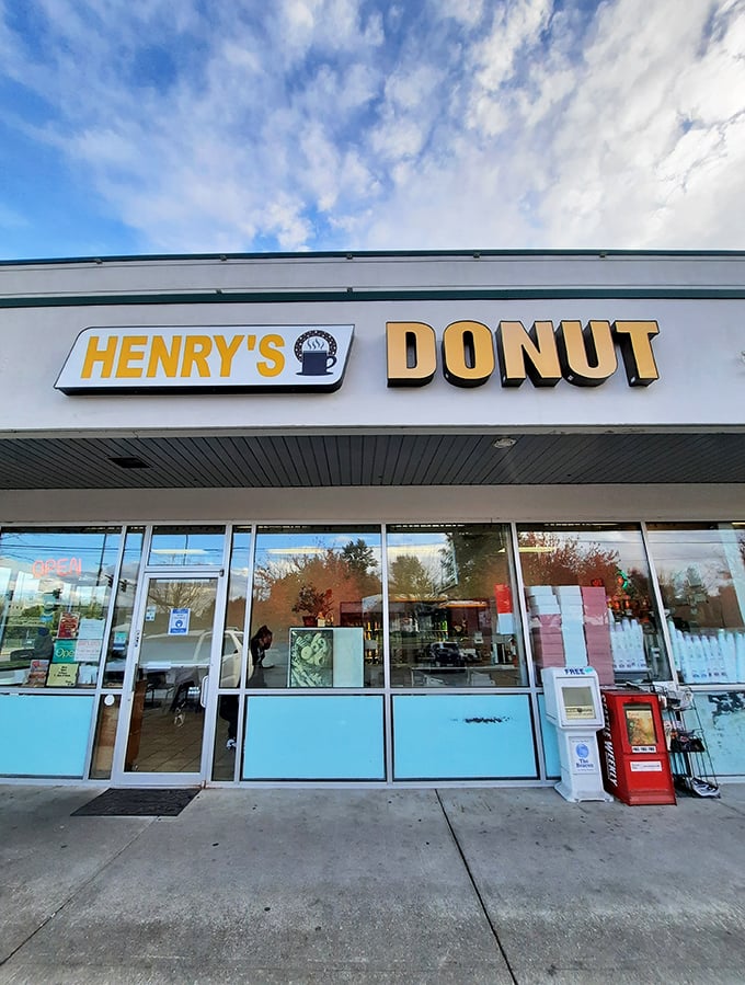 Welcome to donut paradise! Henry's Donut stands proud against the Washington sky, promising sweet delights within its unassuming exterior.