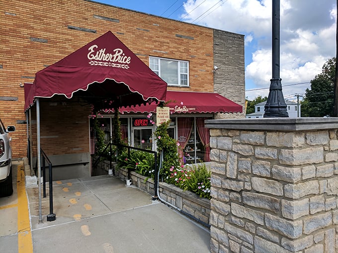 A chocolate lover's beacon! Esther Price Candies' storefront beckons with its classic brick facade and vibrant floral welcome, promising sweet adventures within.