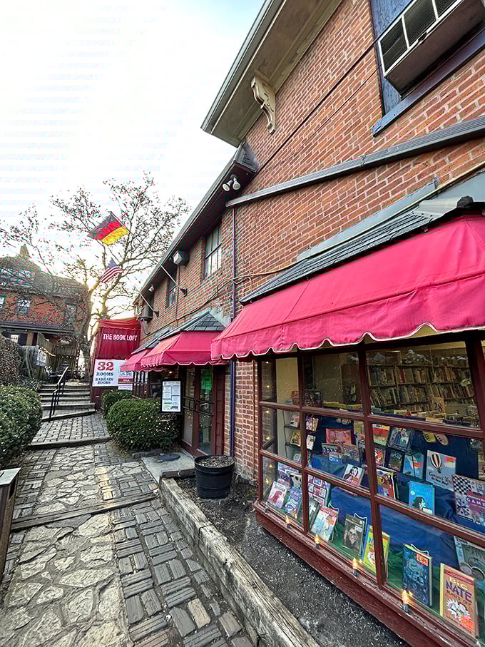 Step into a storybook world! The Book Loft's charming exterior promises literary adventures behind its brick fa&ccedil;ade and vibrant red awnings.