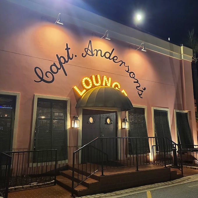 A pink paradise awaits! Capt. Anderson's neon-lit lounge beckons like a siren song, promising seafood delights and tropical libations.