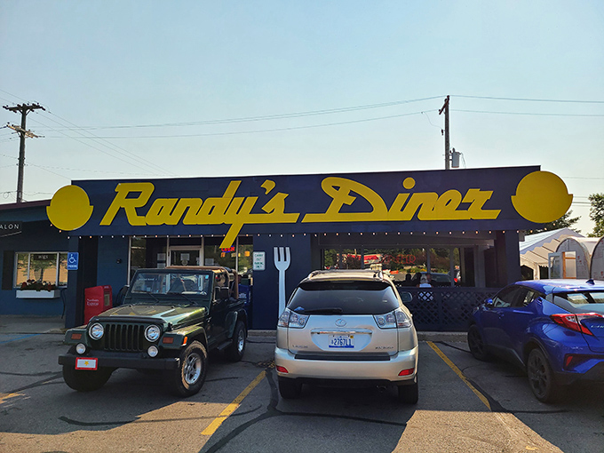 Welcome to breakfast paradise! Randy's Diner's cheerful yellow sign beckons like a sunrise, promising a feast that'll make your taste buds do the happy dance.