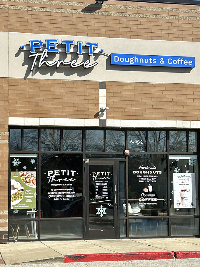 Petit Three's exterior: A beacon of sweetness in Aurora! This modern donut shop's blue signage pops against neutral tones, beckoning sugar lovers from miles around.
