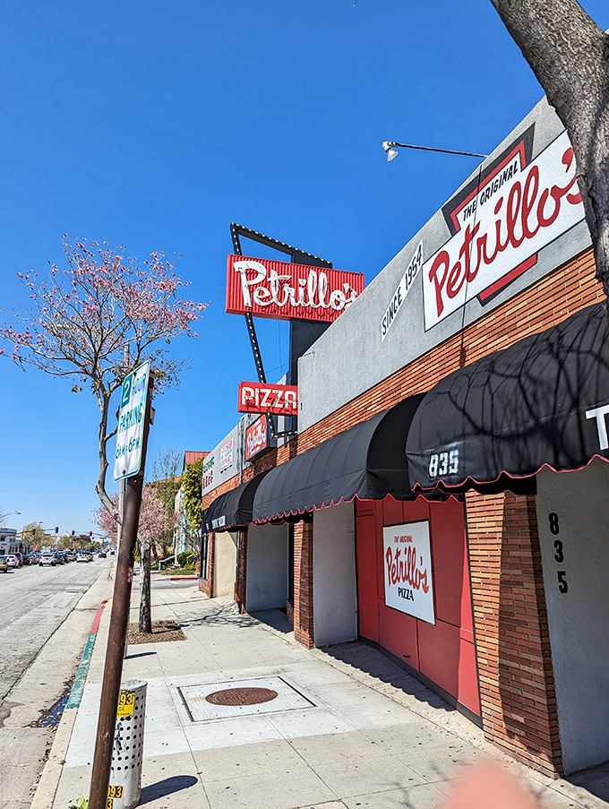 Step into a time machine disguised as a pizzeria! Petrillo's sign has been beckoning pizza lovers since 1954, proving that some things never go out of style.