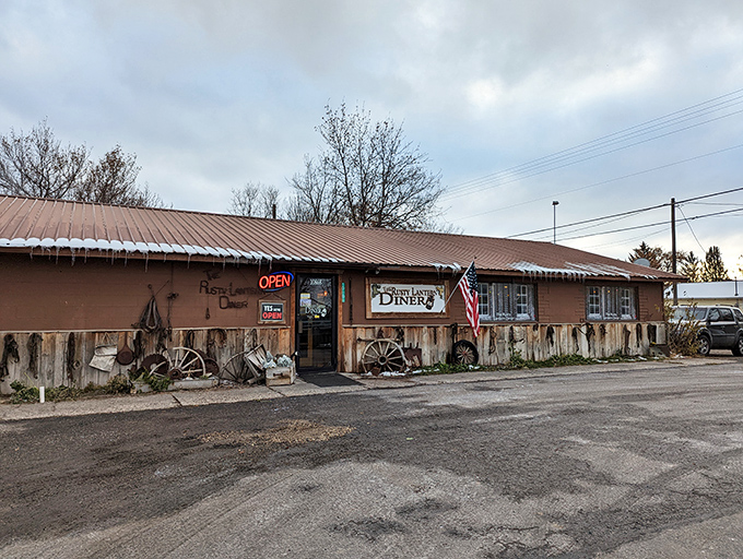 Welcome to the Rusty Lantern Diner, where charm is served in heaping portions! This quaint exterior, adorned with colorful flowers, promises a feast for both eyes and stomach.