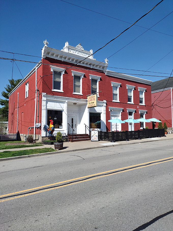 Step into a time warp! This red brick beauty, complete with a technicolor rooster, is like Norman Rockwell's dream come to life.