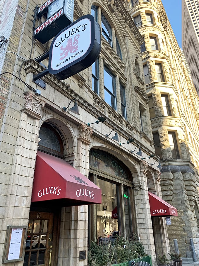 Step into a time machine disguised as a beer garden! Gluek's facade glows with old-world charm, promising a night of Gem&uuml;tlichkeit and frothy steins.