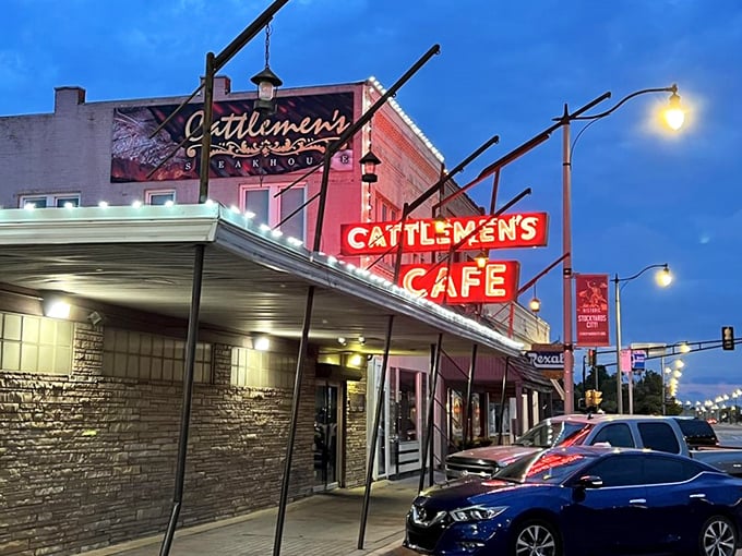 A sign that says "Come for the steak, stay for the history." Cattlemen's iconic exterior beckons meat lovers with its vintage charm and promise of beefy delights.