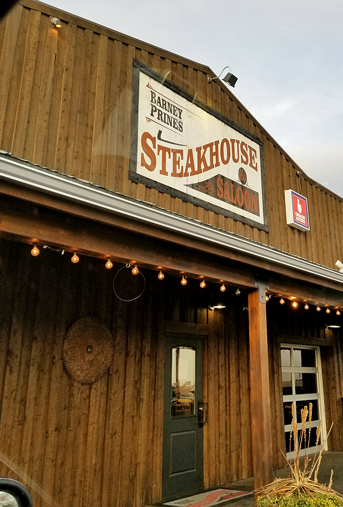 Welcome to beef paradise! Barney Prine's rustic exterior promises a steak-lover's dream, with those red umbrellas beckoning like beacons of deliciousness.